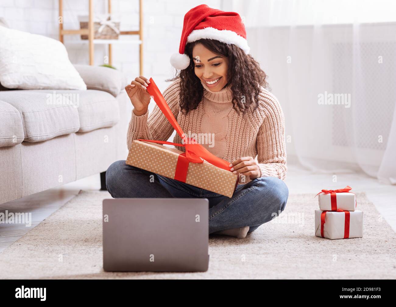 African woman unwrap gift hi-res stock photography and images - Alamy