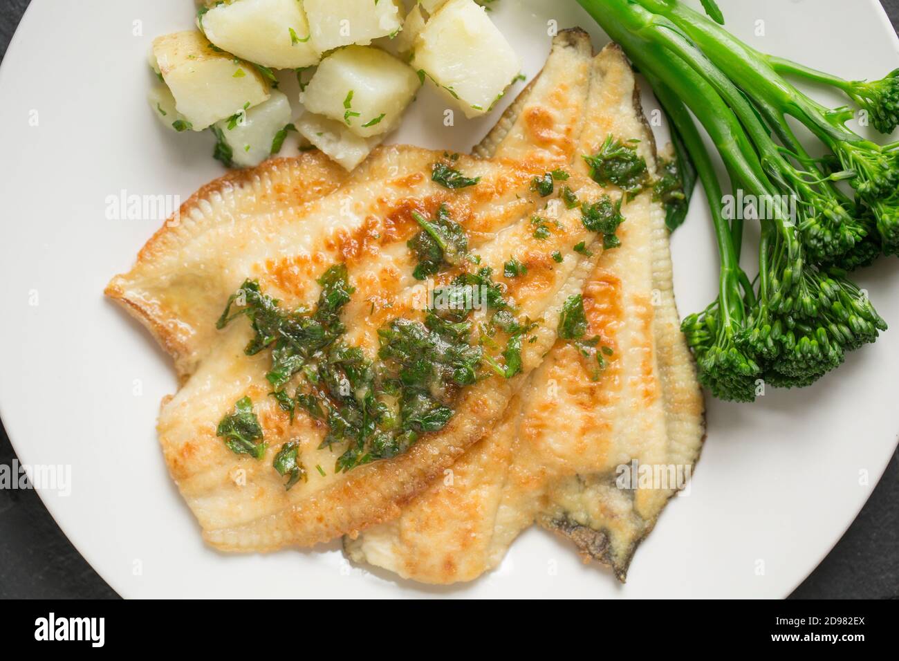 Two cooked plaice fillets from a plaice, Pleuronectes platessa, that ...