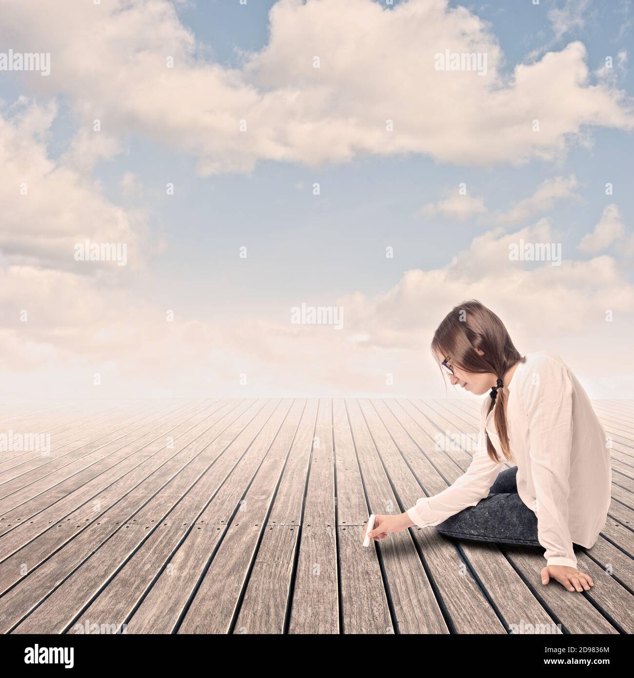 young girl drawing with chalk on a wharf Stock Photo - Alamy