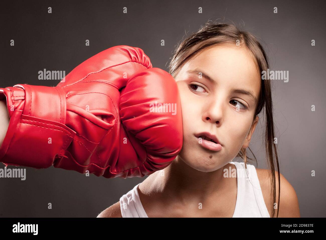 little girl and red boxing globe hitting her face Stock Photo - Alamy