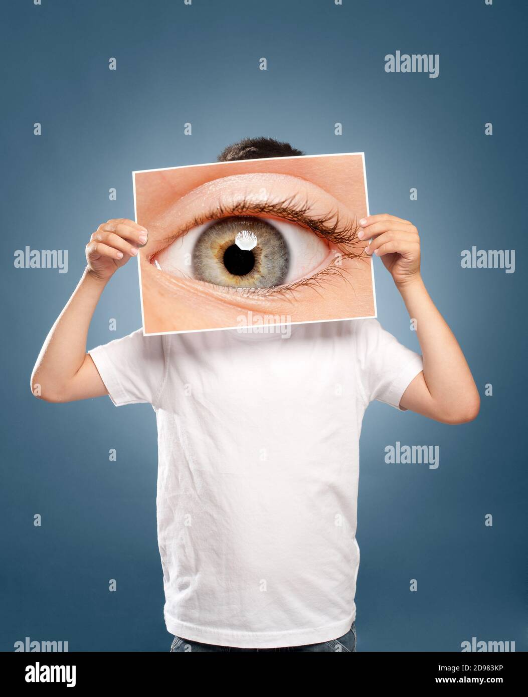 kid holding a picture of an eye watching Stock Photo - Alamy