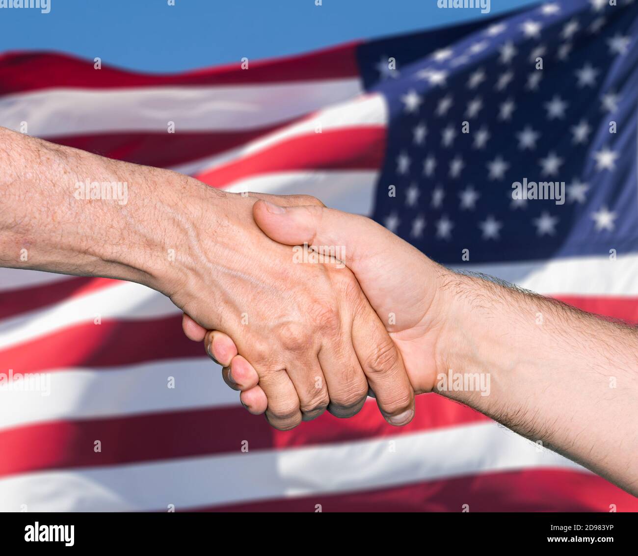 The USA flag and shaking hands of two male people Stock Photo - Alamy