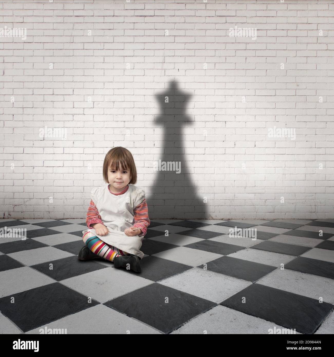 little girl with queen shadow on a checkered floor Stock Photo - Alamy