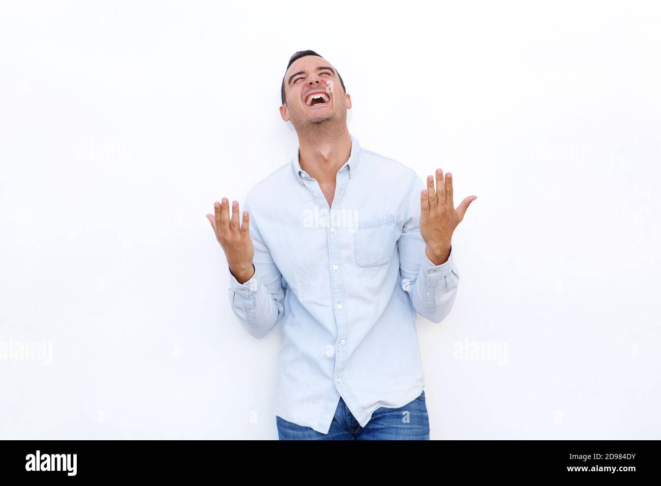 Portrait of happy man laughing with hands raised Stock Photo - Alamy