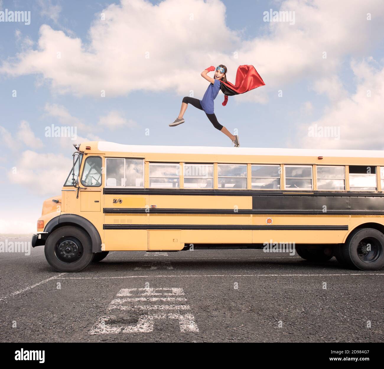 little girl wearing a superhero costume on a school bus. Back to school ...