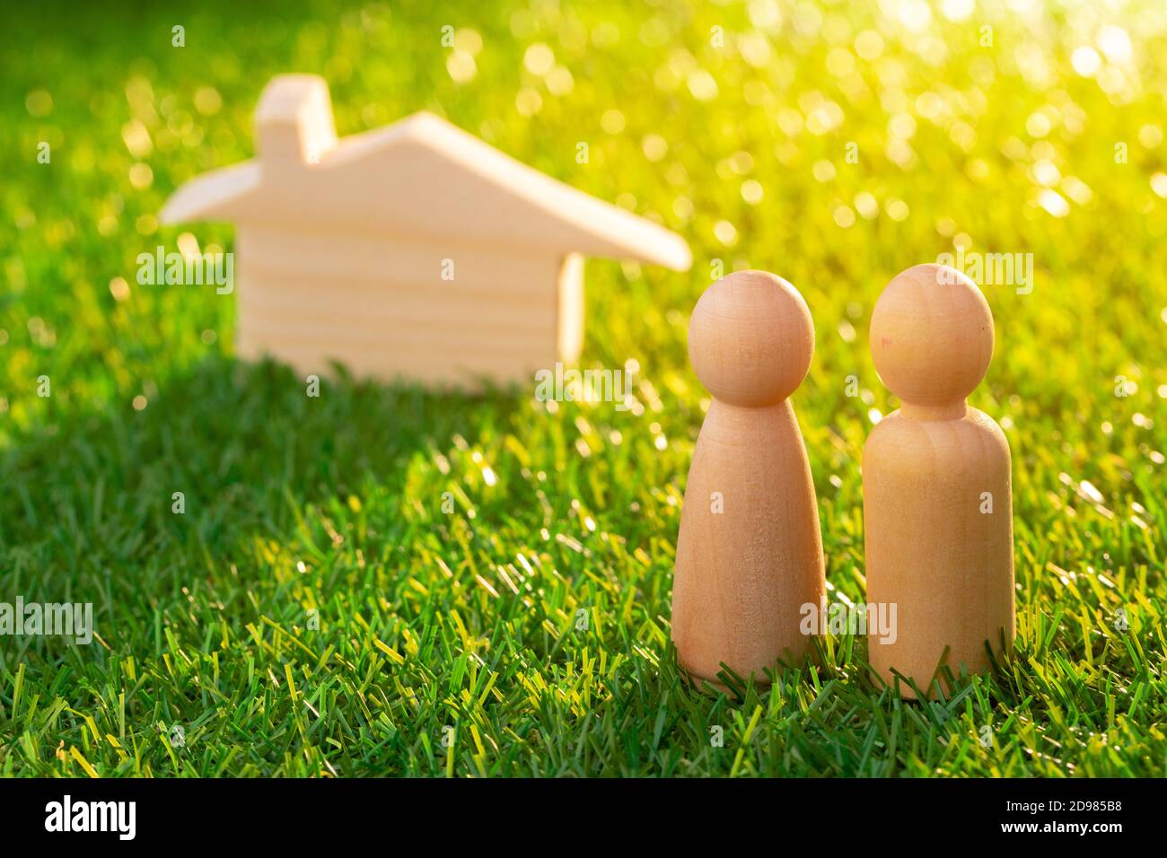 Wooden men figures and toy wooden house Stock Photo - Alamy