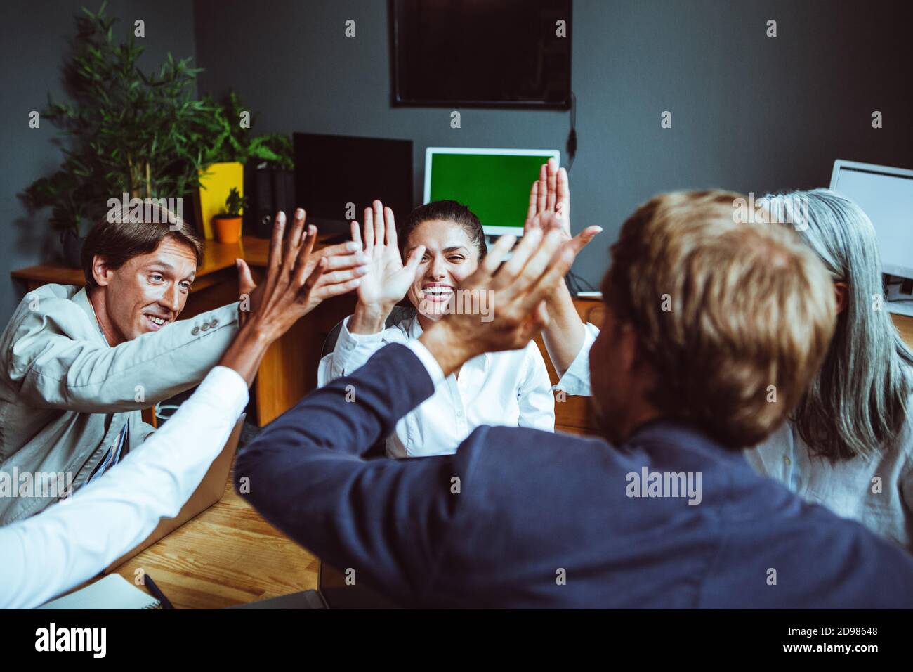 Business people giving each other high five and clapping. Business team ...