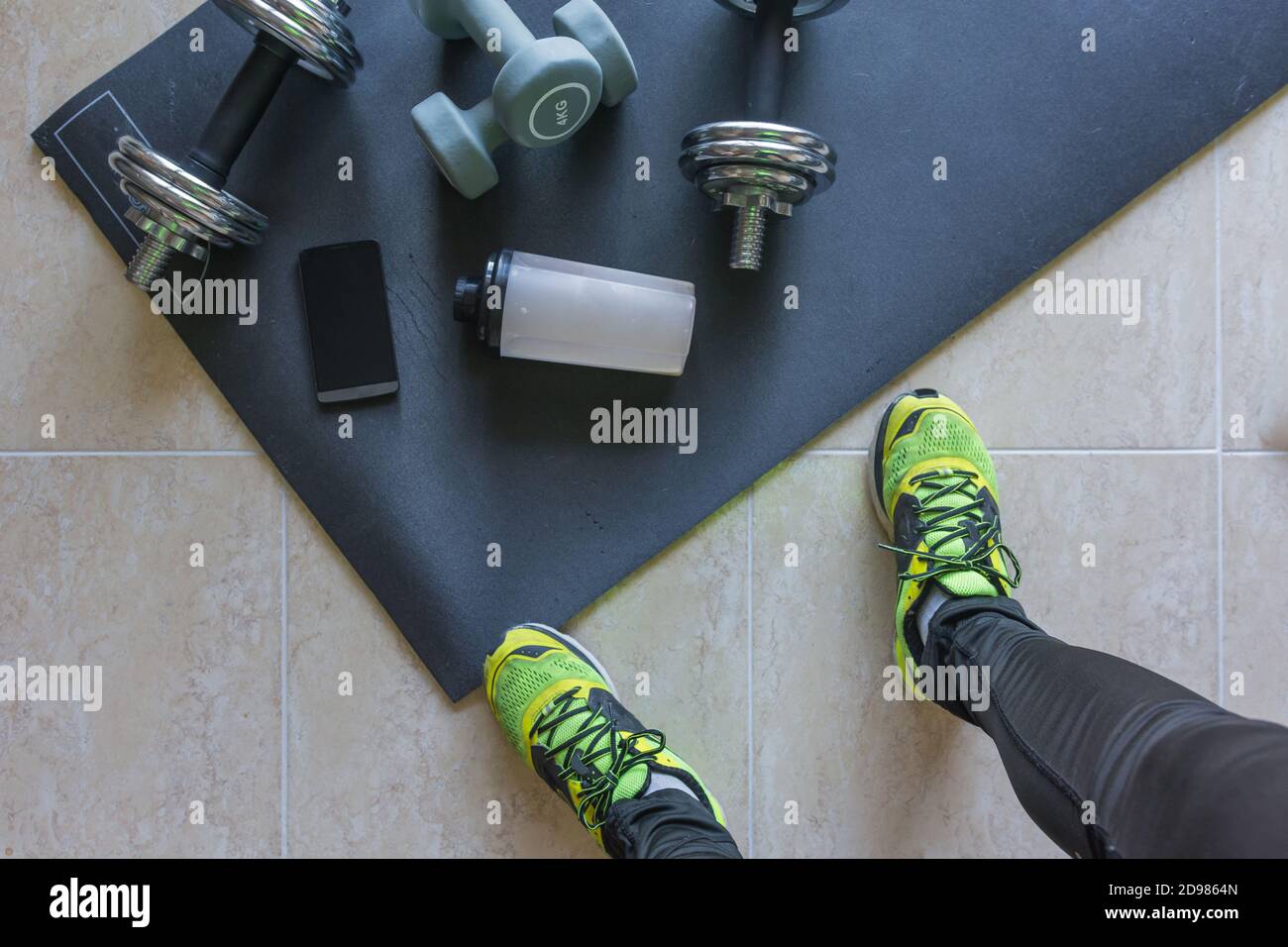 Dumbbell and mat training at home, and to drink a protein shake Stock ...