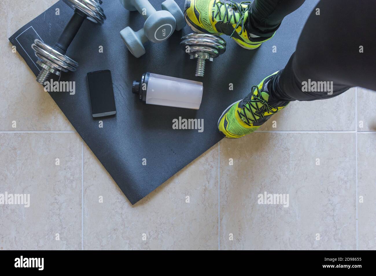 Dumbbell and mat training at home, and to drink a protein shake Stock ...