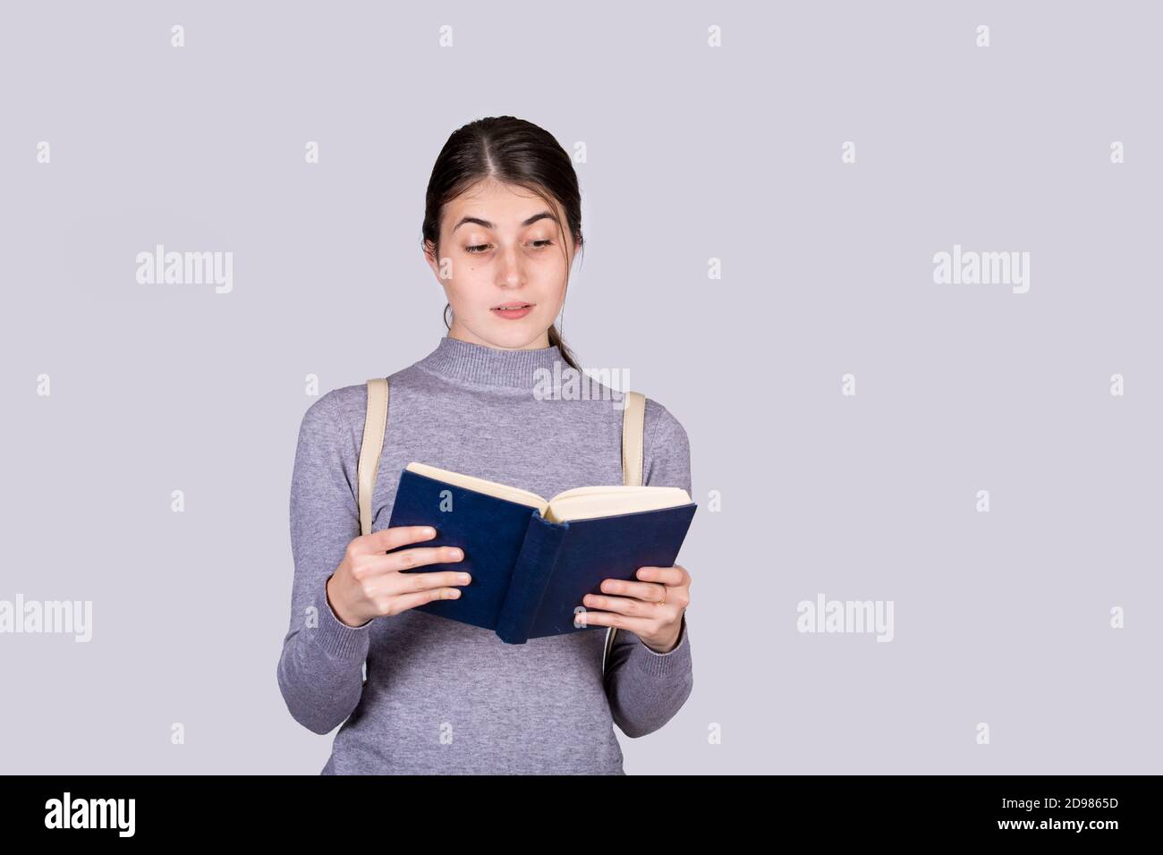 Shocked student holding book hi-res stock photography and images - Alamy