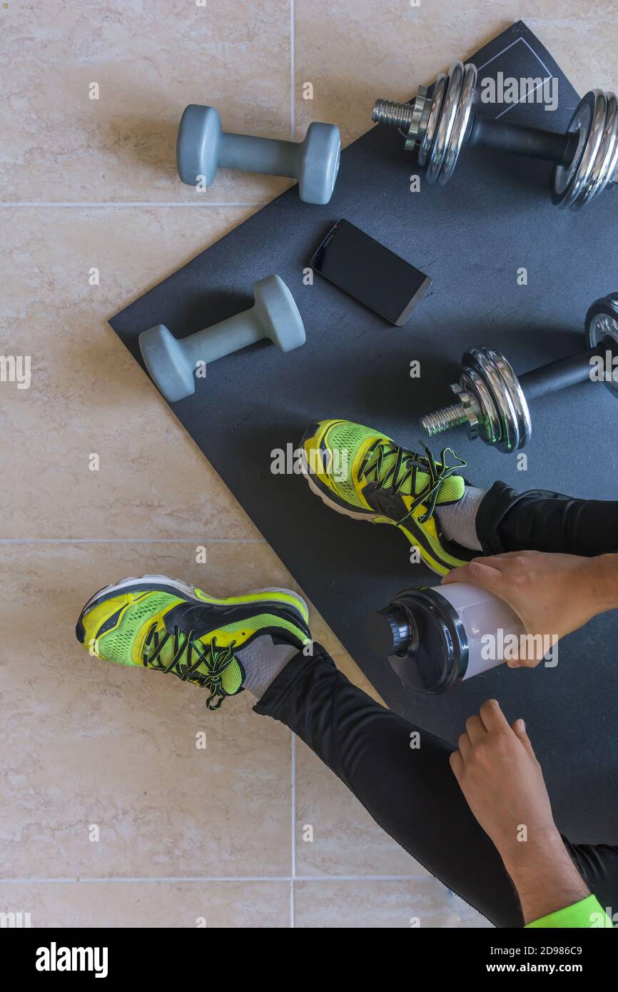 Dumbbell and mat training at home, and to drink a protein shake Stock ...