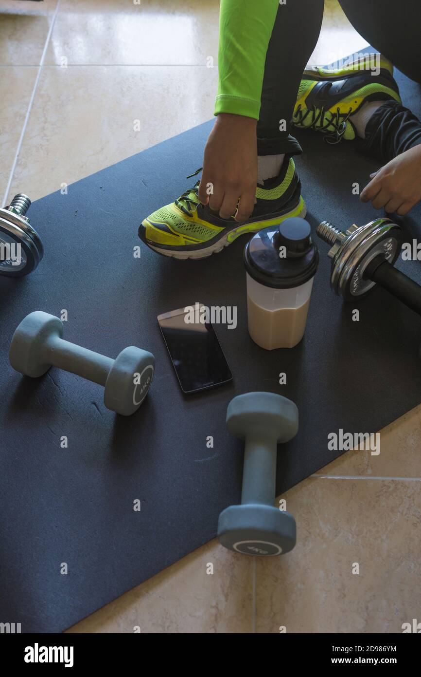 Dumbbell and mat training at home, and to drink a protein shake Stock ...