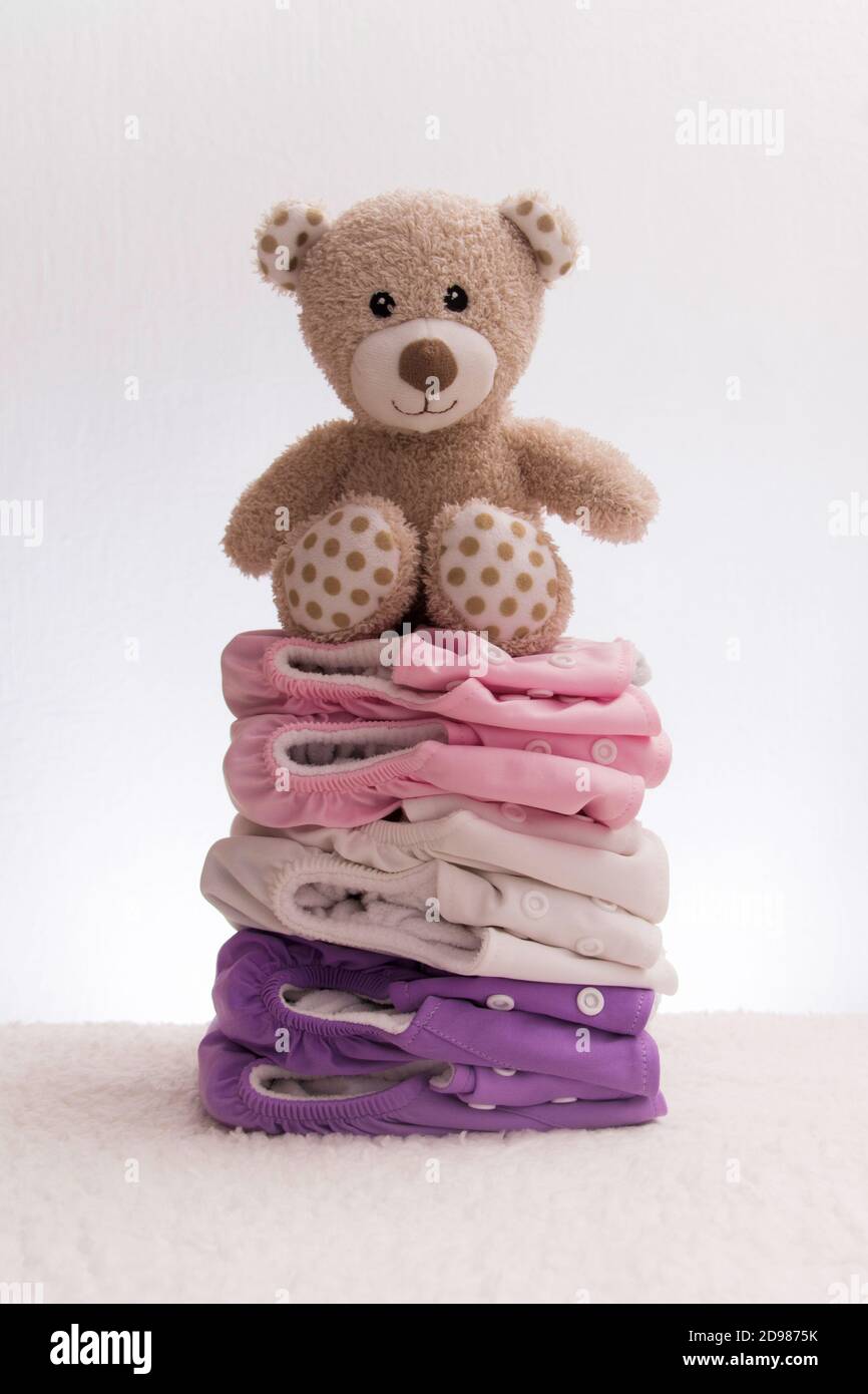 Baby cloth eco-friendly diapers with a teddy bear Stock Photo - Alamy