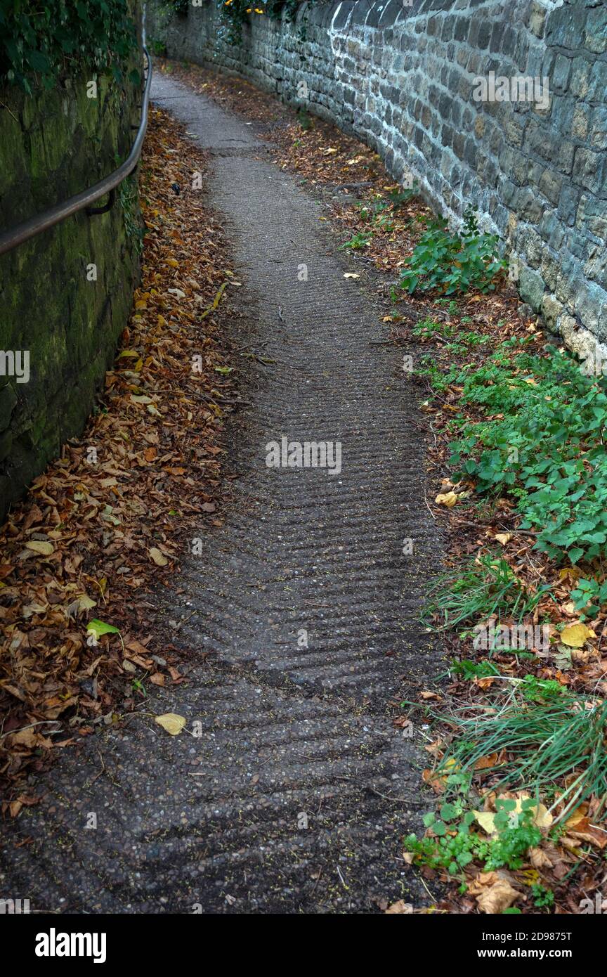 Steep narrow path with stone wall and autumn leaves Stock Photo - Alamy
