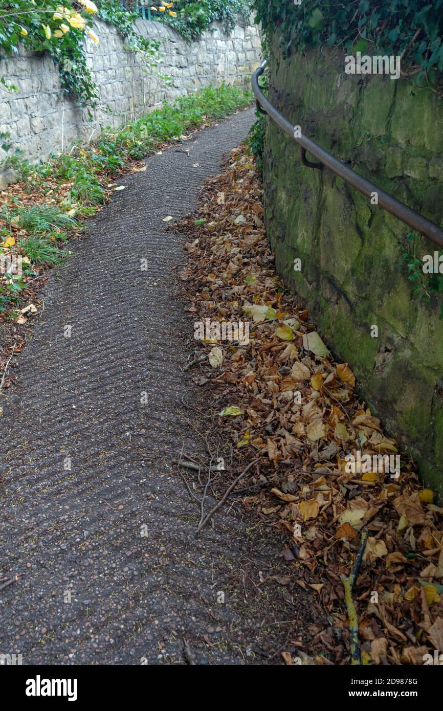 Steep narrow path with stone wall and autumn leaves Stock Photo - Alamy