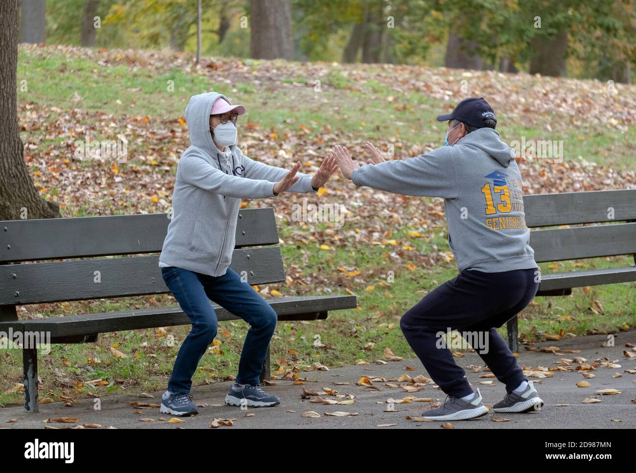 Exercise partners work out together in a park in Queens, New York City ...
