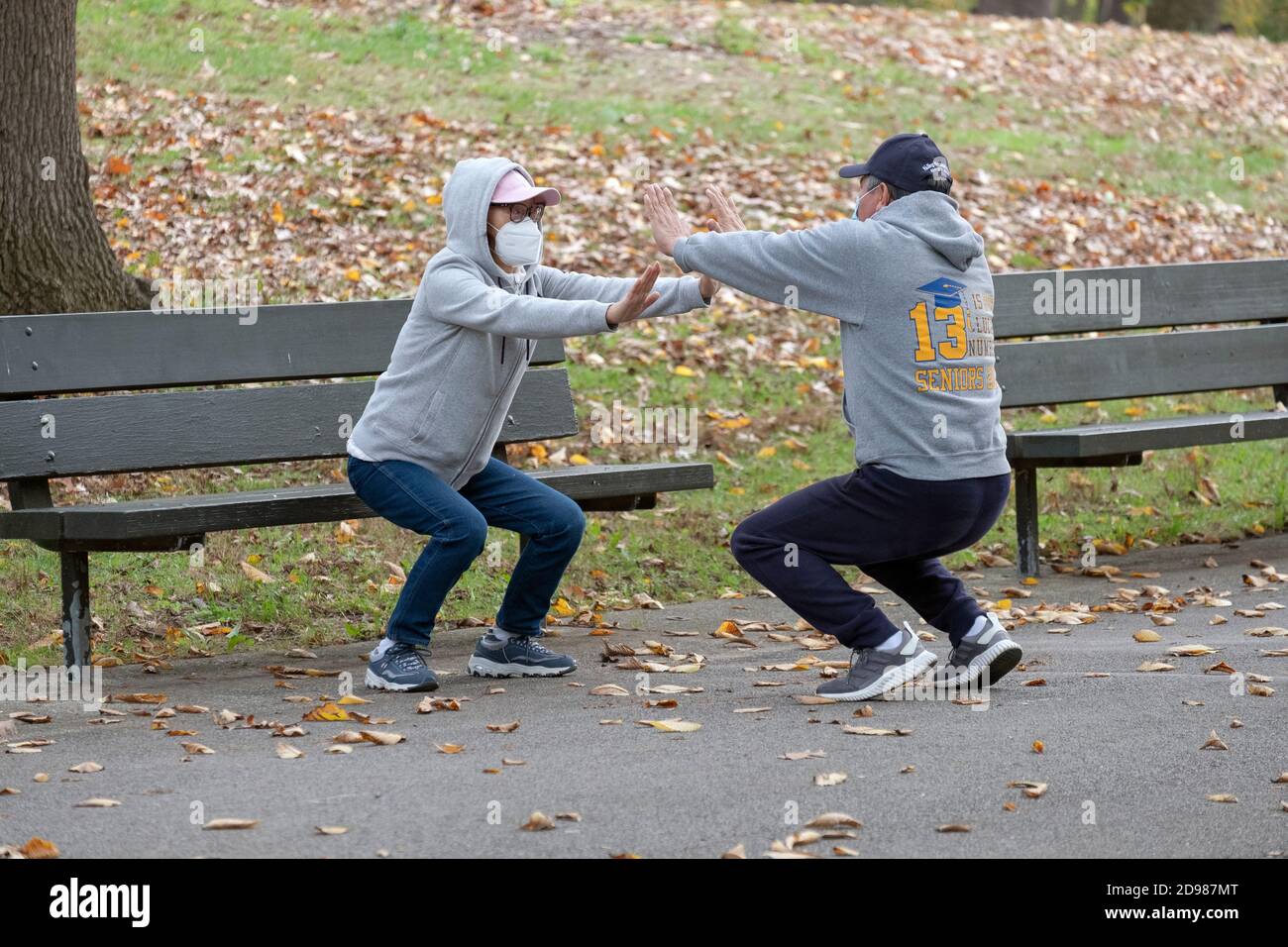 Exercise partners work out together in a park in Queens, New York City ...
