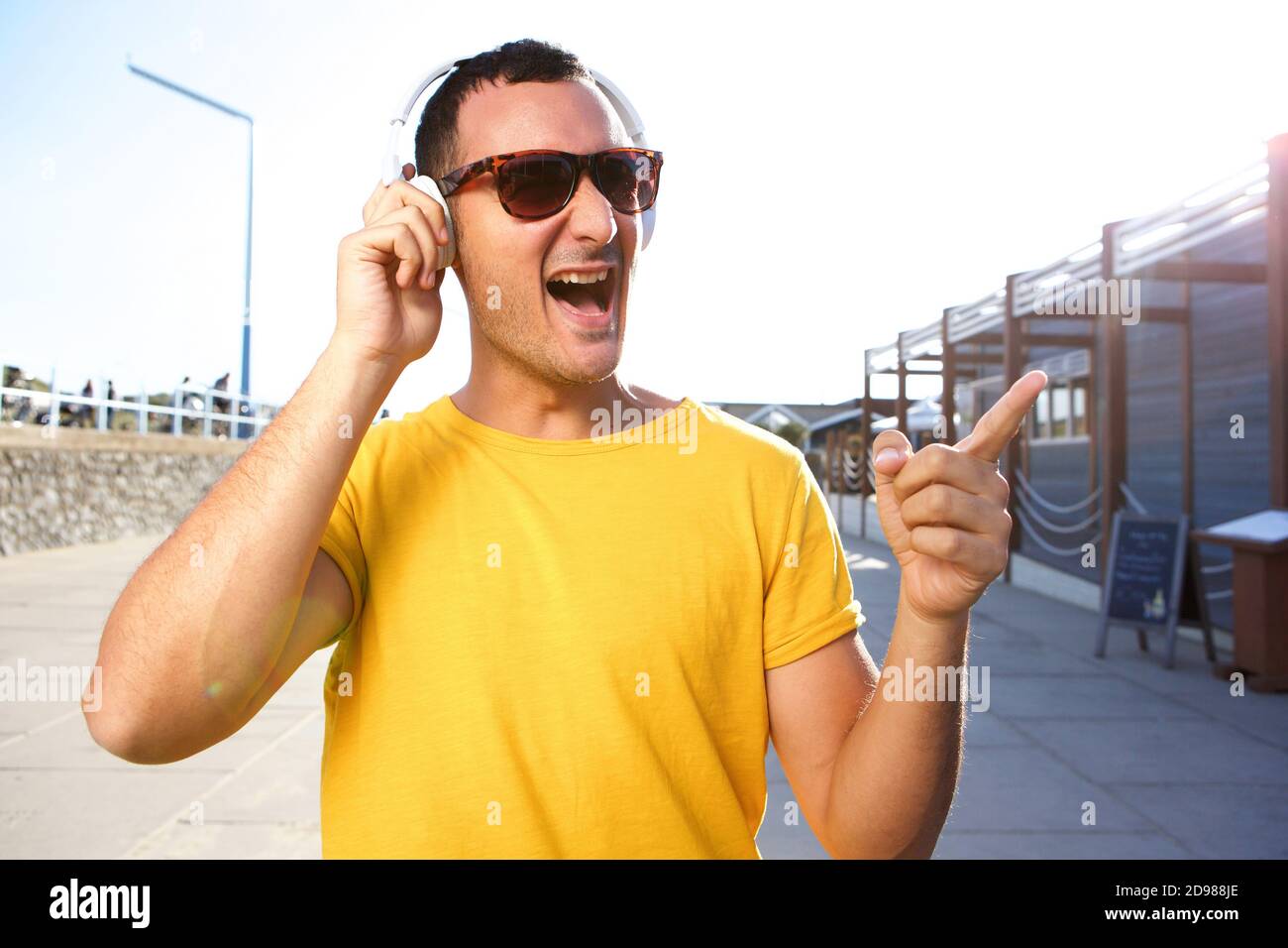 Portrait of cool guy listening to music with headphones Stock Photo - Alamy
