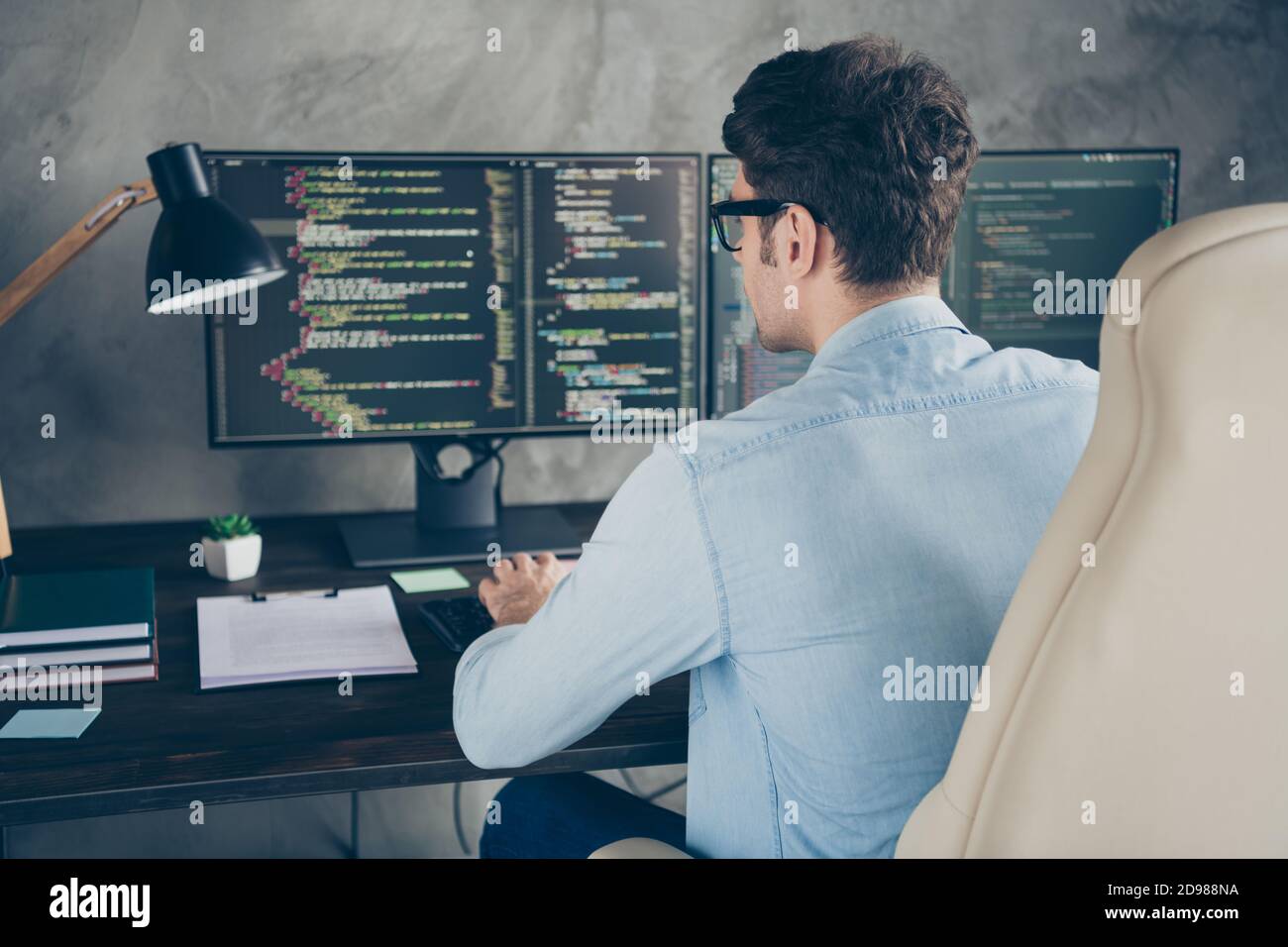 Rear back behind view portrait of his he nice skilled focused busy geek ...