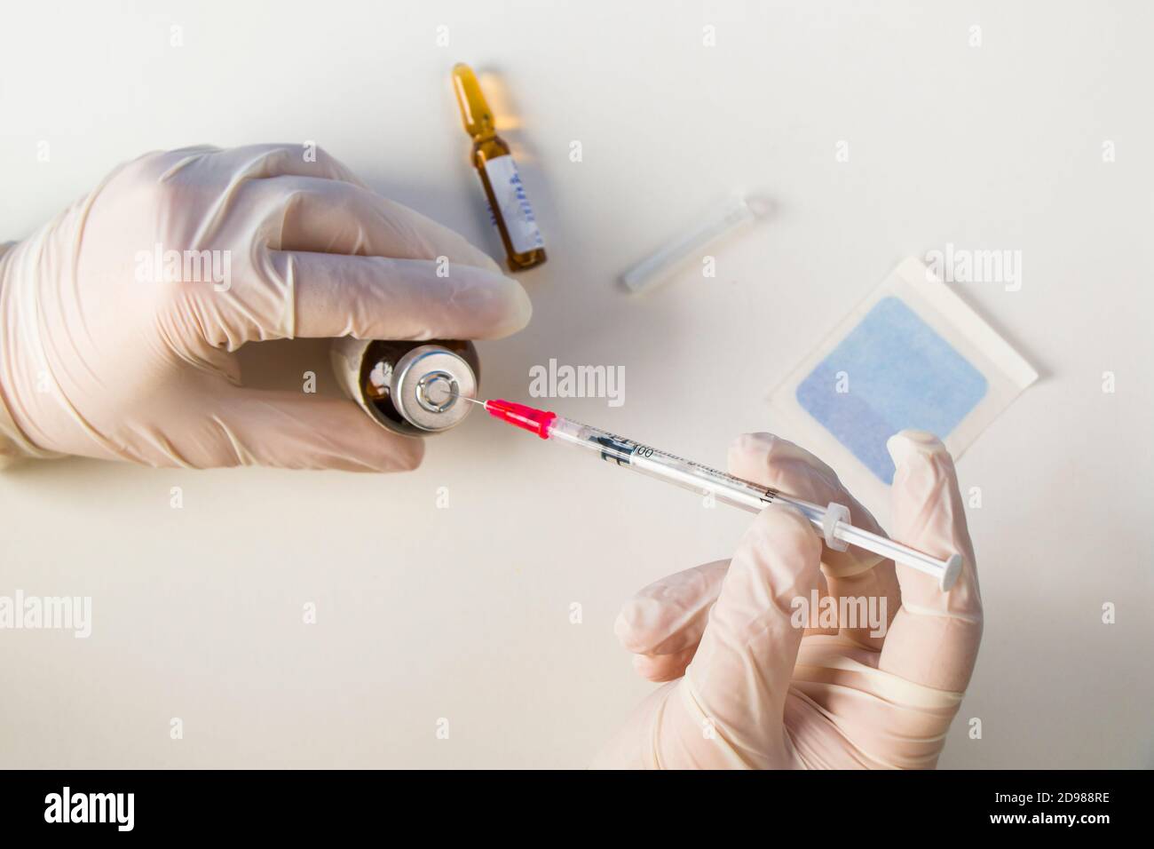 Vaccine in the needle, hand with glove holding needle, drugs and ampule ...