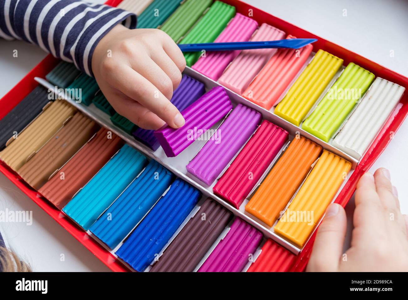 Child's hands with colorful clay. Toddler playing and creating toys ...