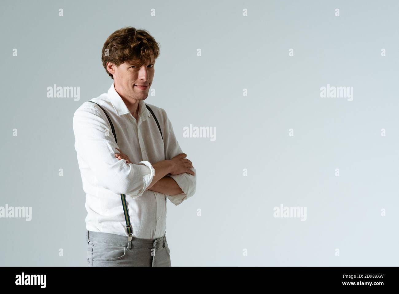 Young foxy man with hands folded on chest. Isolated on white background ...