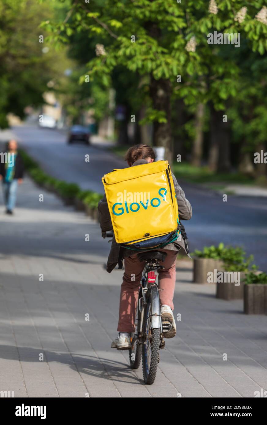 Lviv, Ukraine - May 25, 2020: A Glovo food delivery courier delivers ...