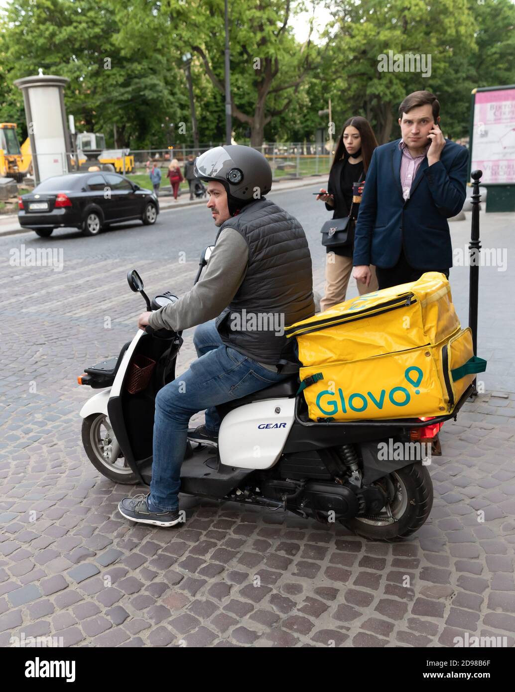 Lviv, Ukraine - May 25, 2020: A Glovo food delivery courier delivers ...