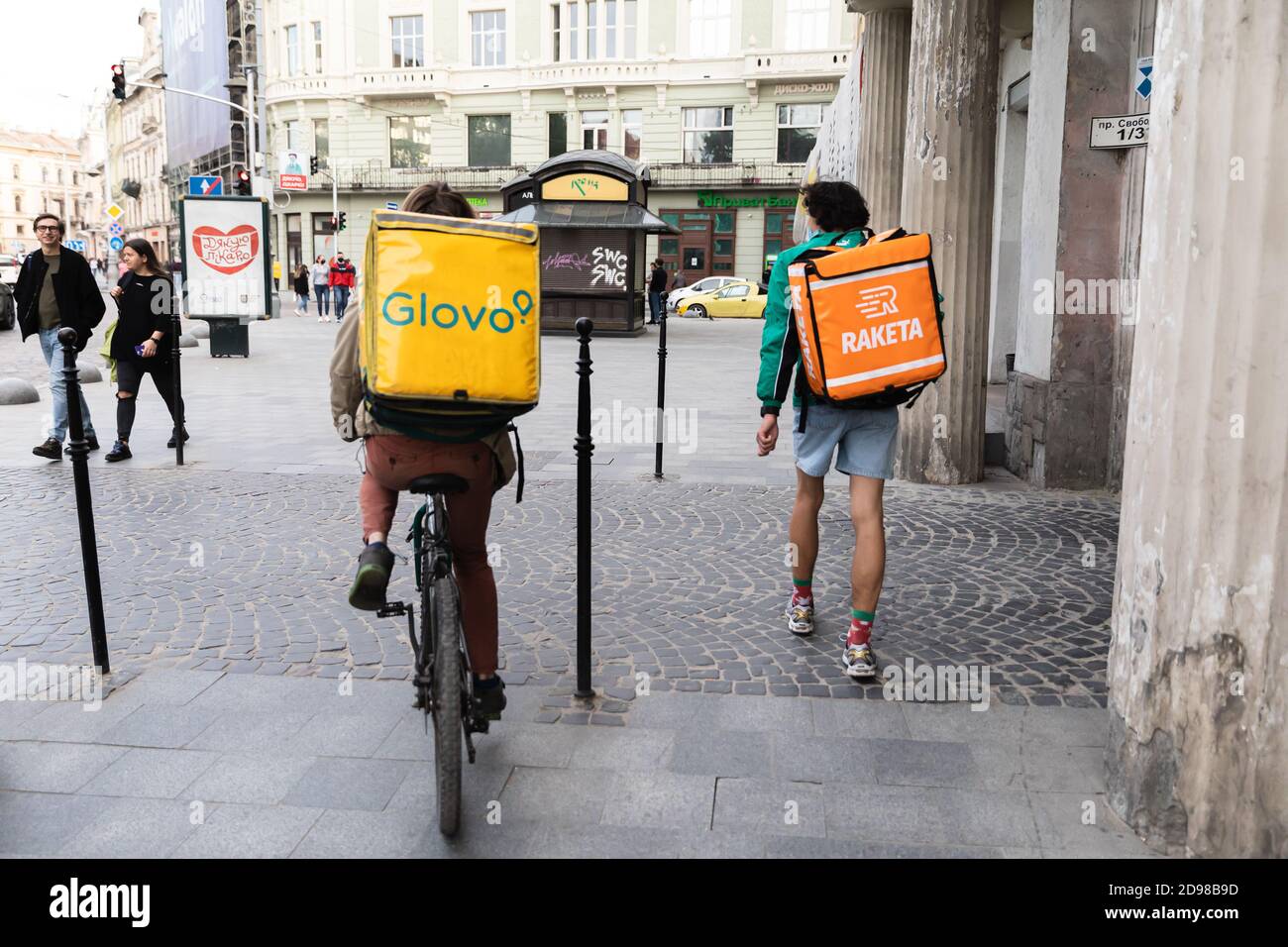 Lviv, Ukraine - May 25, 2020: A Glovo and Raketa food delivery couriers ...