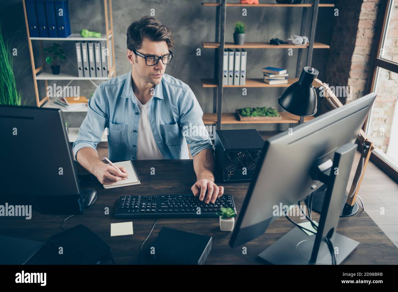 Portrait of his he nice attractive focused experienced geek guy writing ...