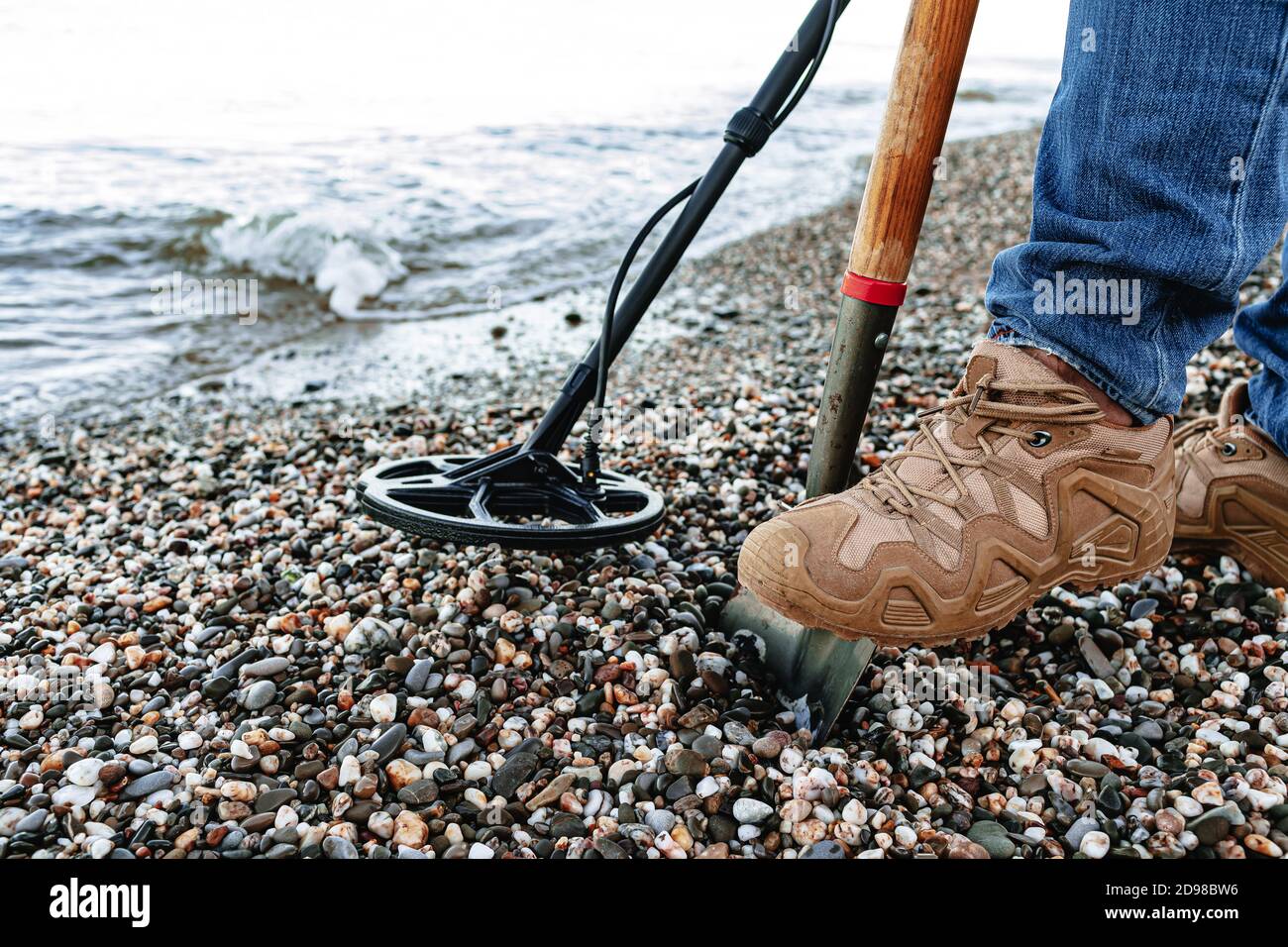 Metal detector coil in action above the ground Stock Photo - Alamy