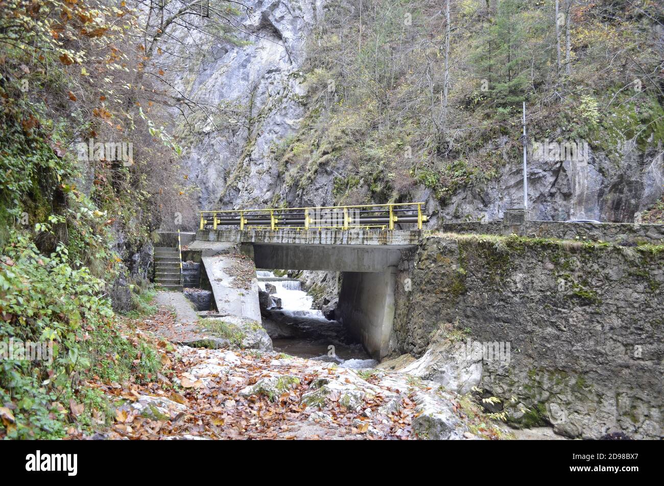 Mountain Bridge over running water Stock Photo - Alamy