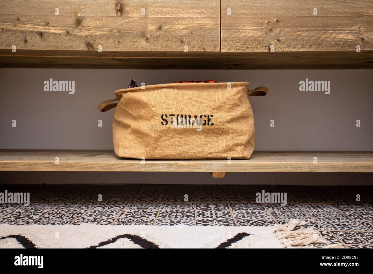 Basket for storage on wooden shelf in modern home, retro stylish ...