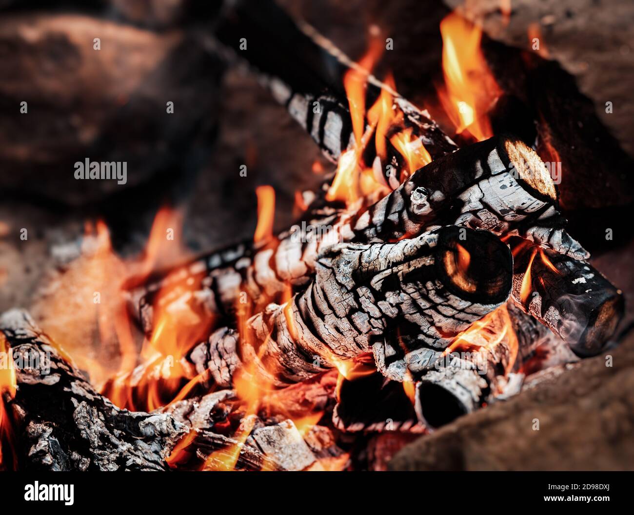 Wood fire with ash, сloseup. Beautiful fire with flames charred wood ...