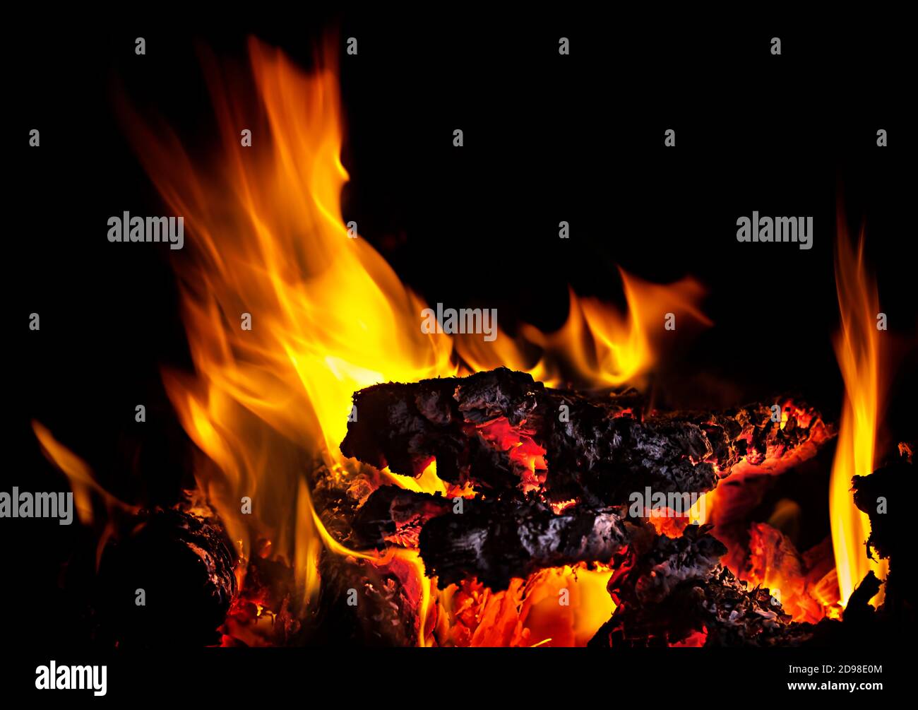Live coals with fire flames on black background Stock Photo - Alamy