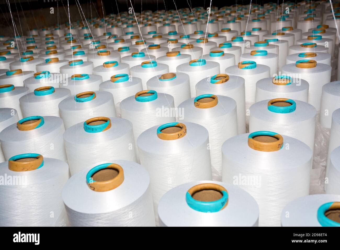 A pattern of white cotton spools with threads. An old system manual ...