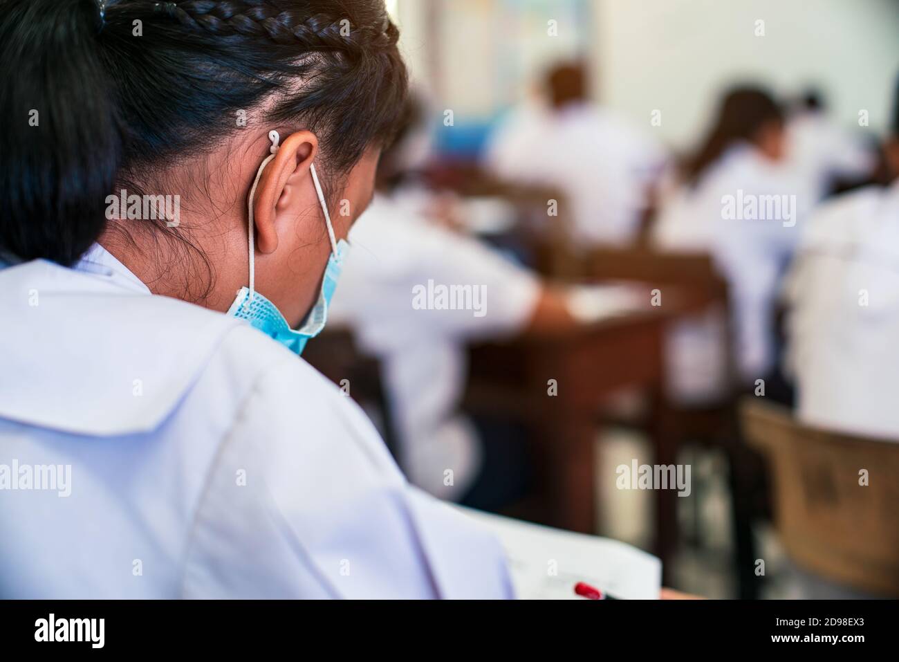 Students wearing mask for protect covid-19 and doing exam in classroom ...