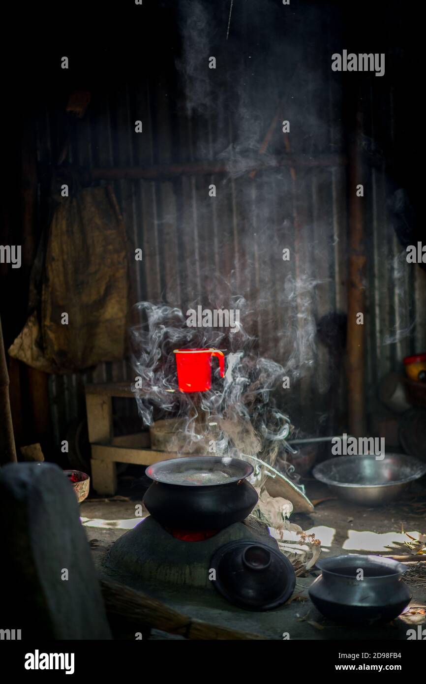 Cooking Rice over traditional charcoal burning clay stove in the ...