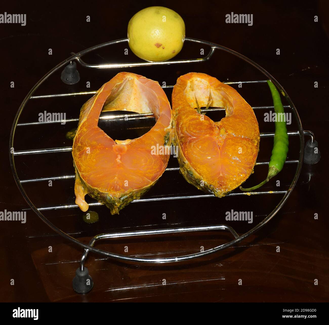 Marinated raw fish steak kept for barbecue on a grille Stock Photo - Alamy