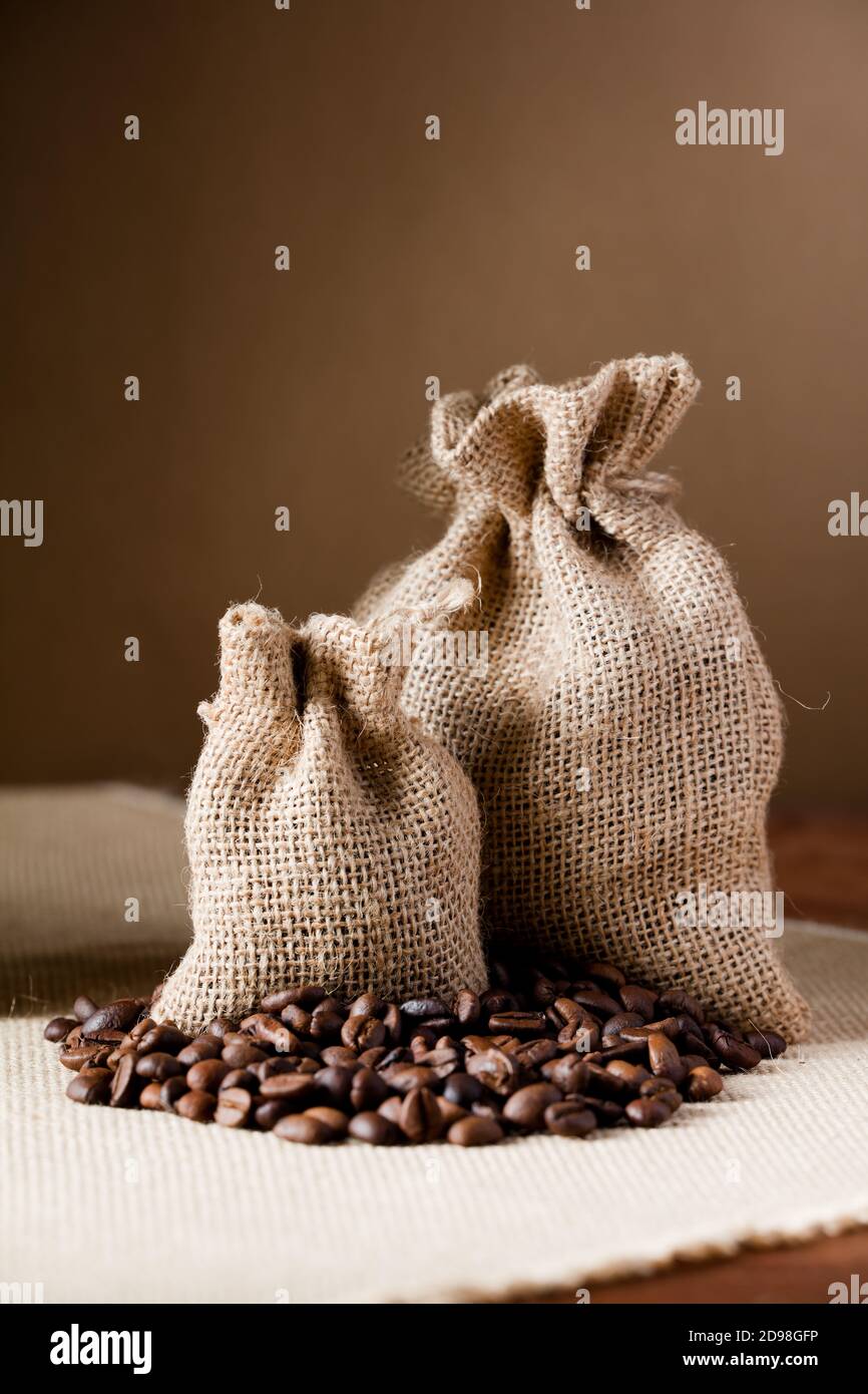 cloth sacks (raffia), with coffee beans and brown background Stock ...