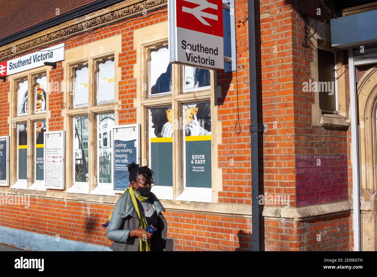 View of a middle-aged black woman walking past the entrance to Southend ...