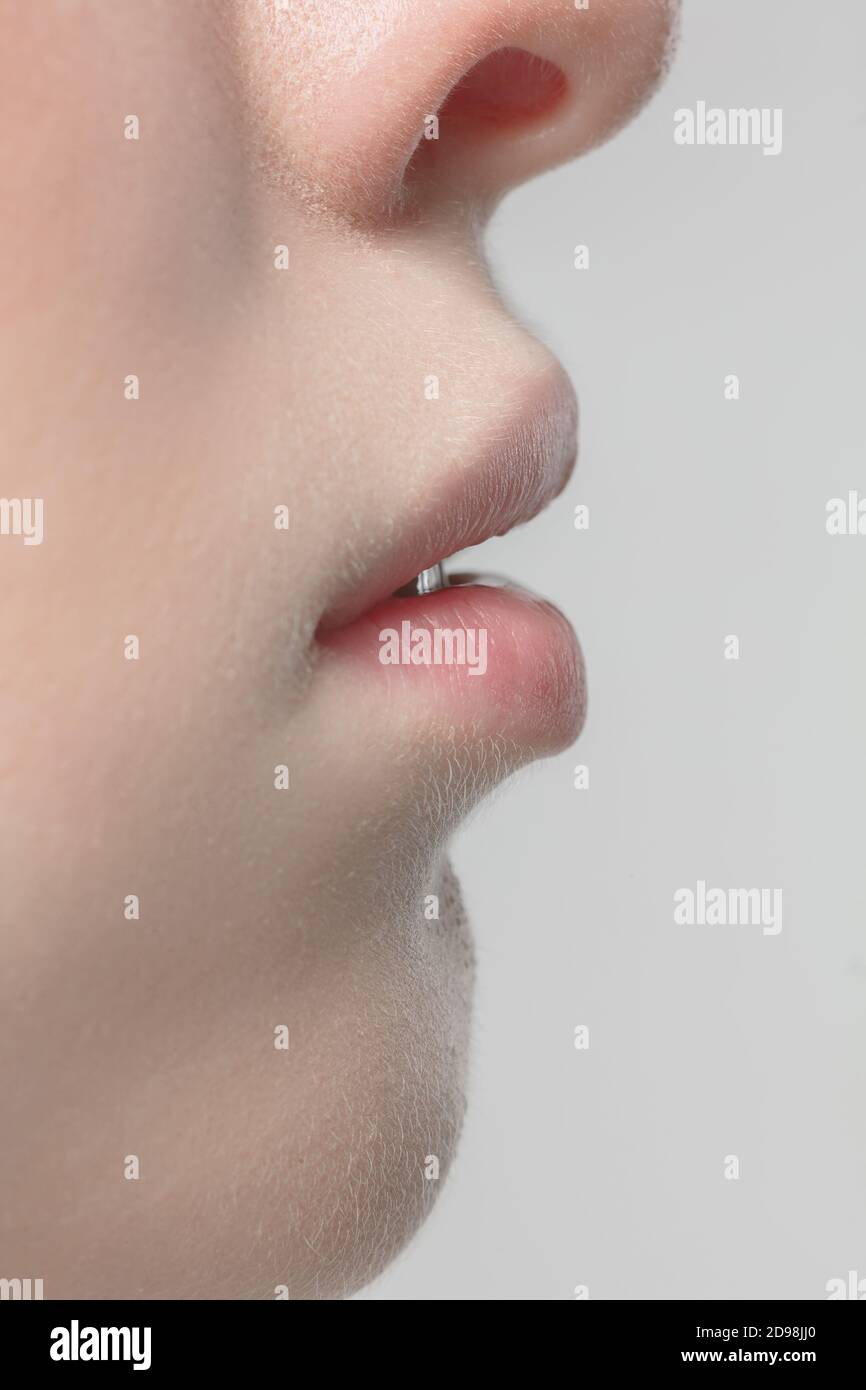 Lips and teeth. Close up portrait of beautiful albino female model ...