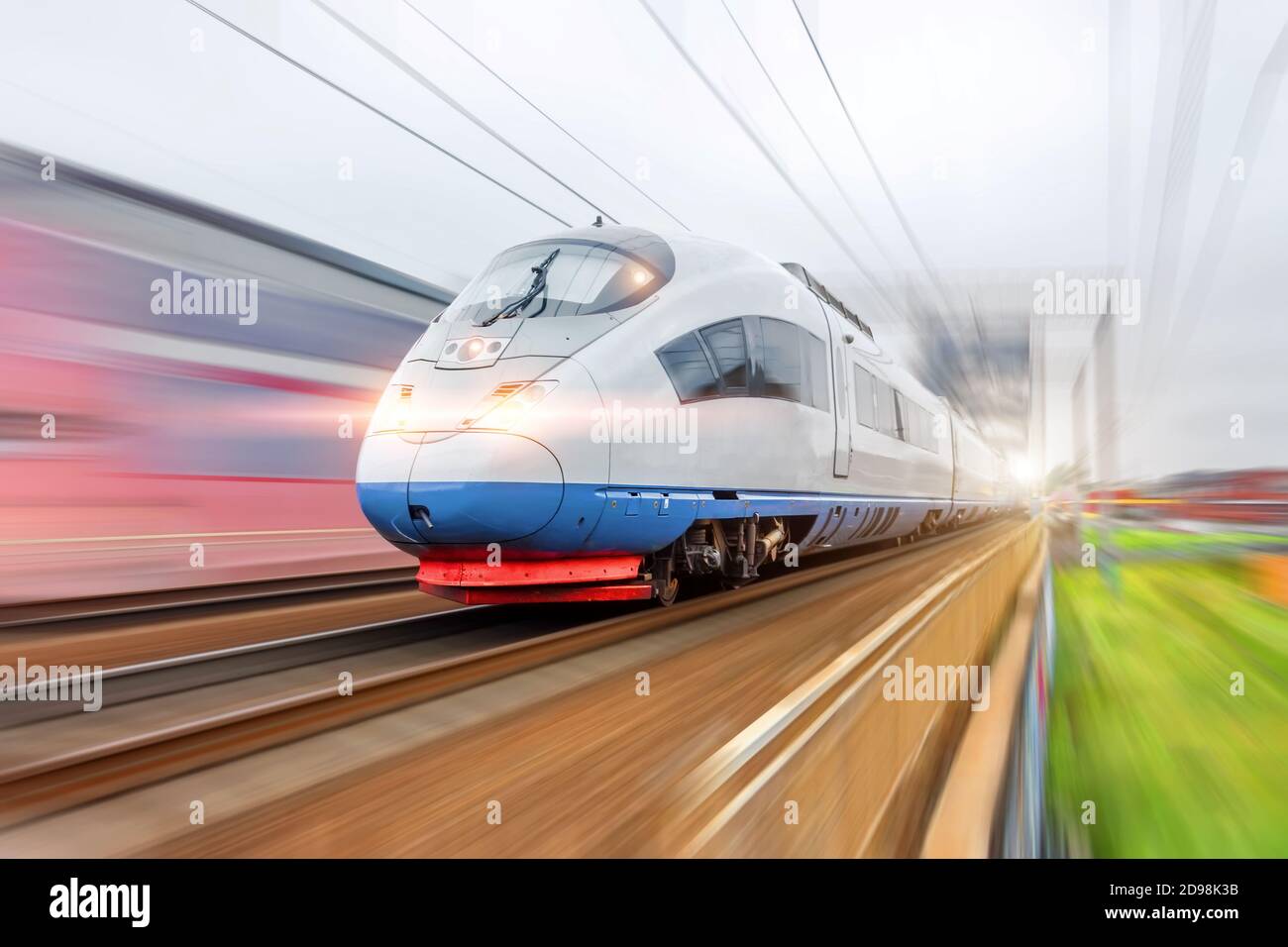 Electric train with glowing lights traveling at high speed Stock Photo ...