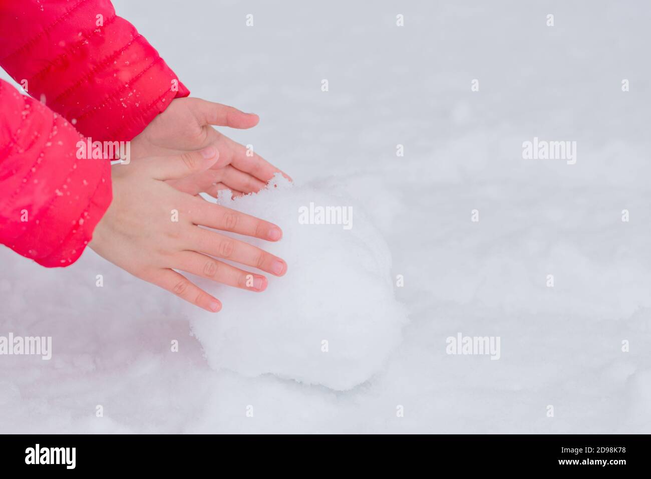 A child makes a snowman with a phone outdoors in the forest Stock Photo ...