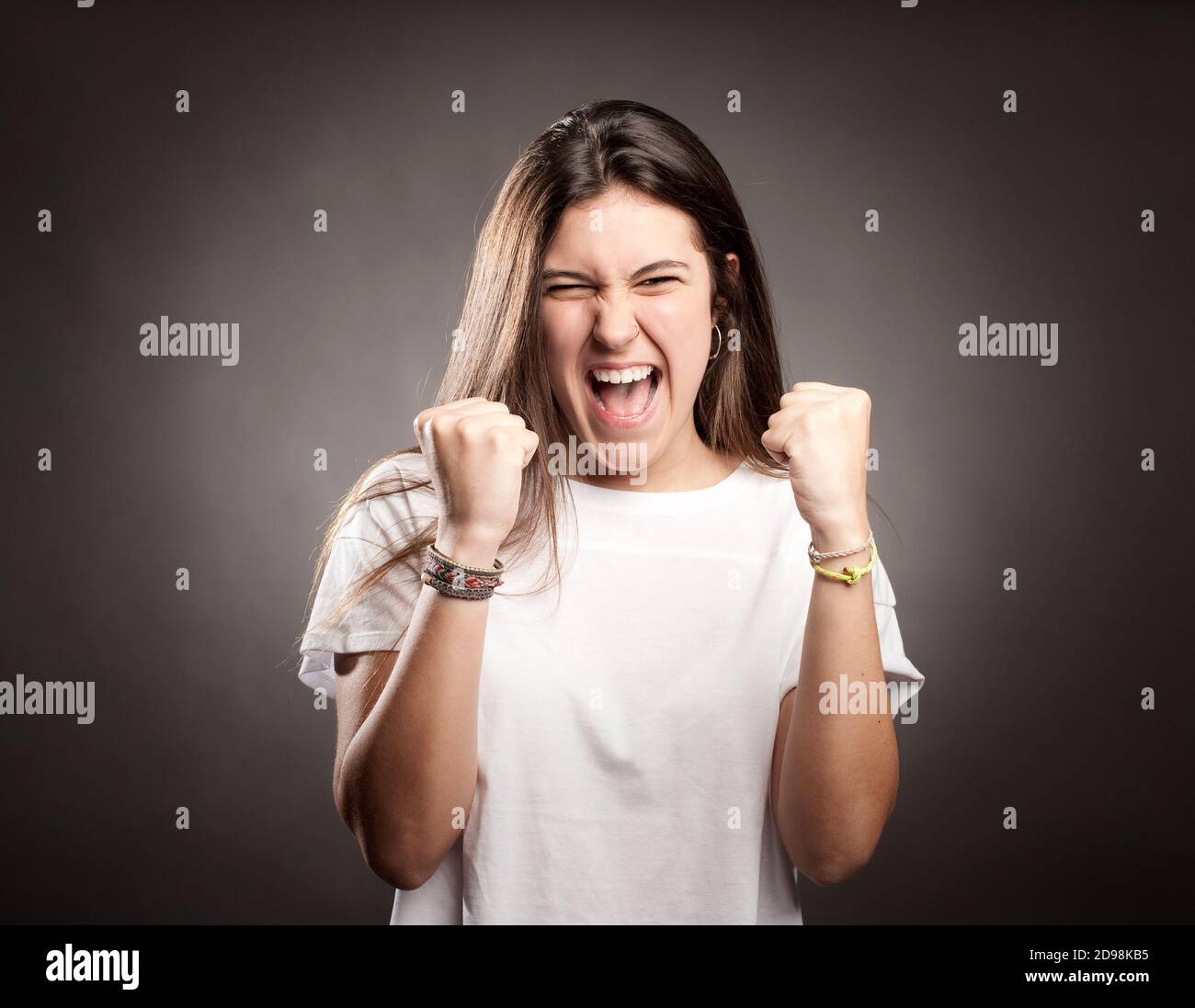 portrait of a young woman celebrating being a winner Stock Photo - Alamy