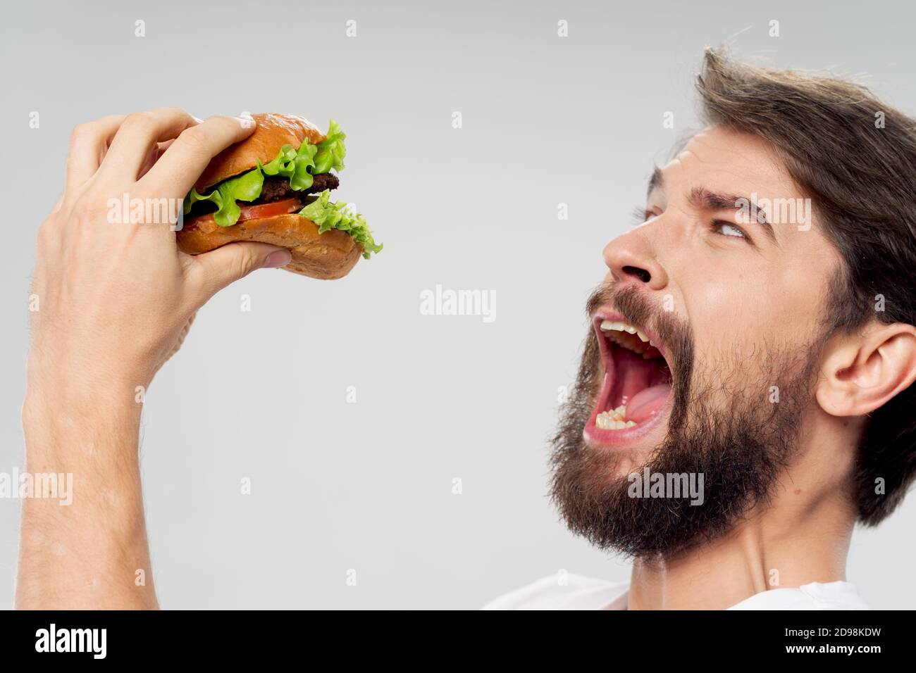 Man with hamburger fast food diet wide open mouth Stock Photo - Alamy