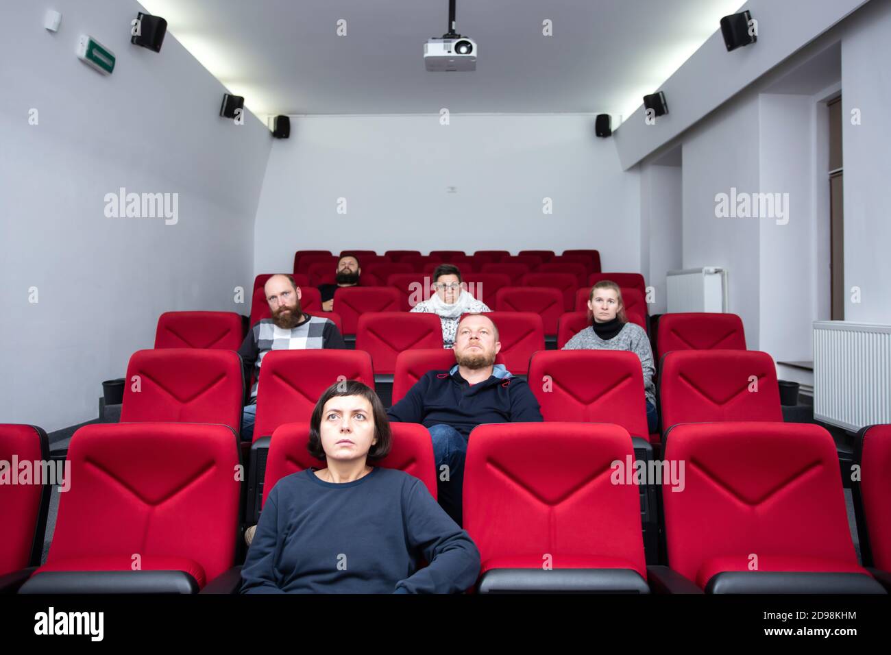 People in cinema keeping distance away to avoid physical contact ...