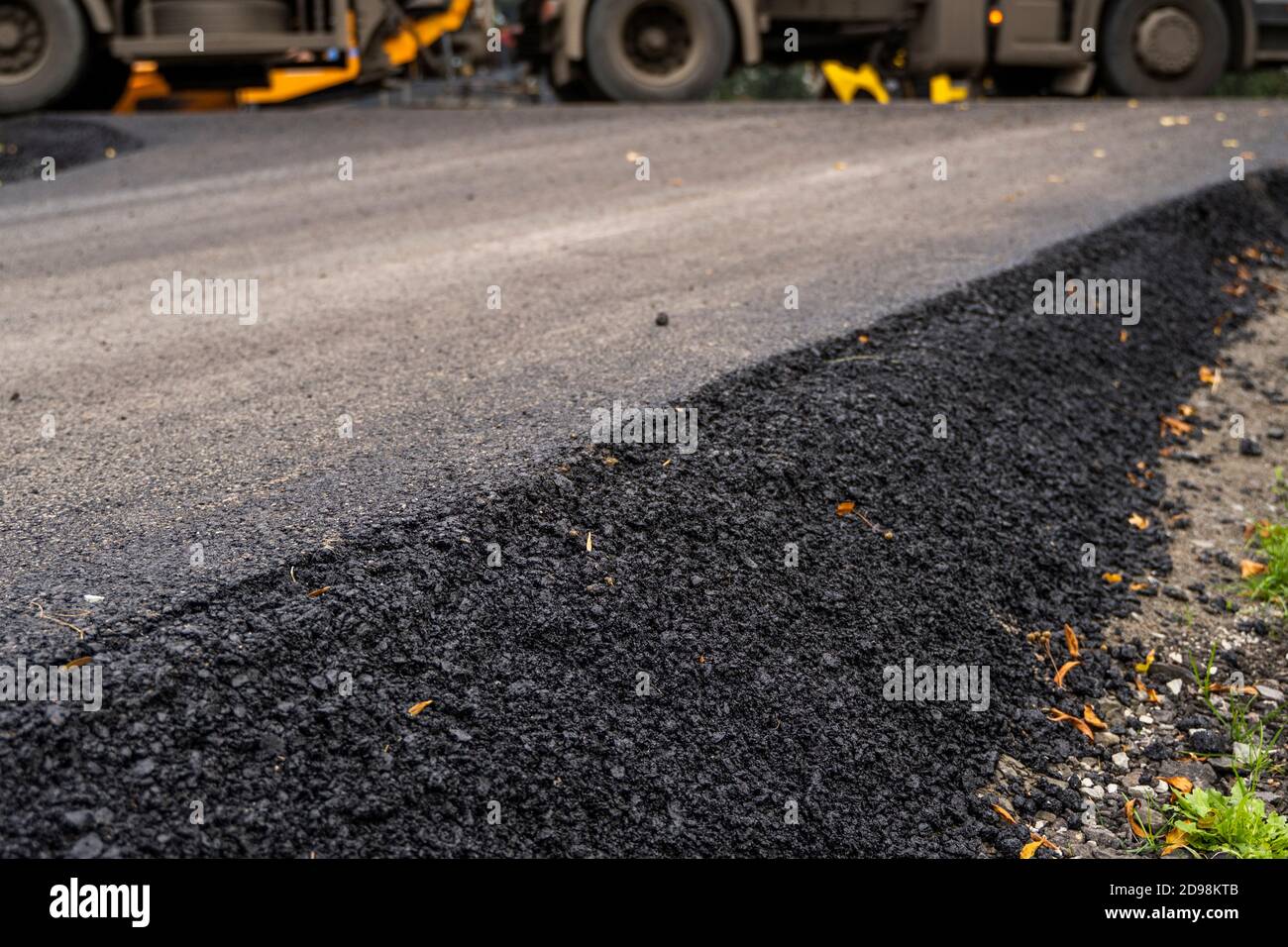 A large layer of fresh hot asphalt. Layer of asphalt raw material in a ...
