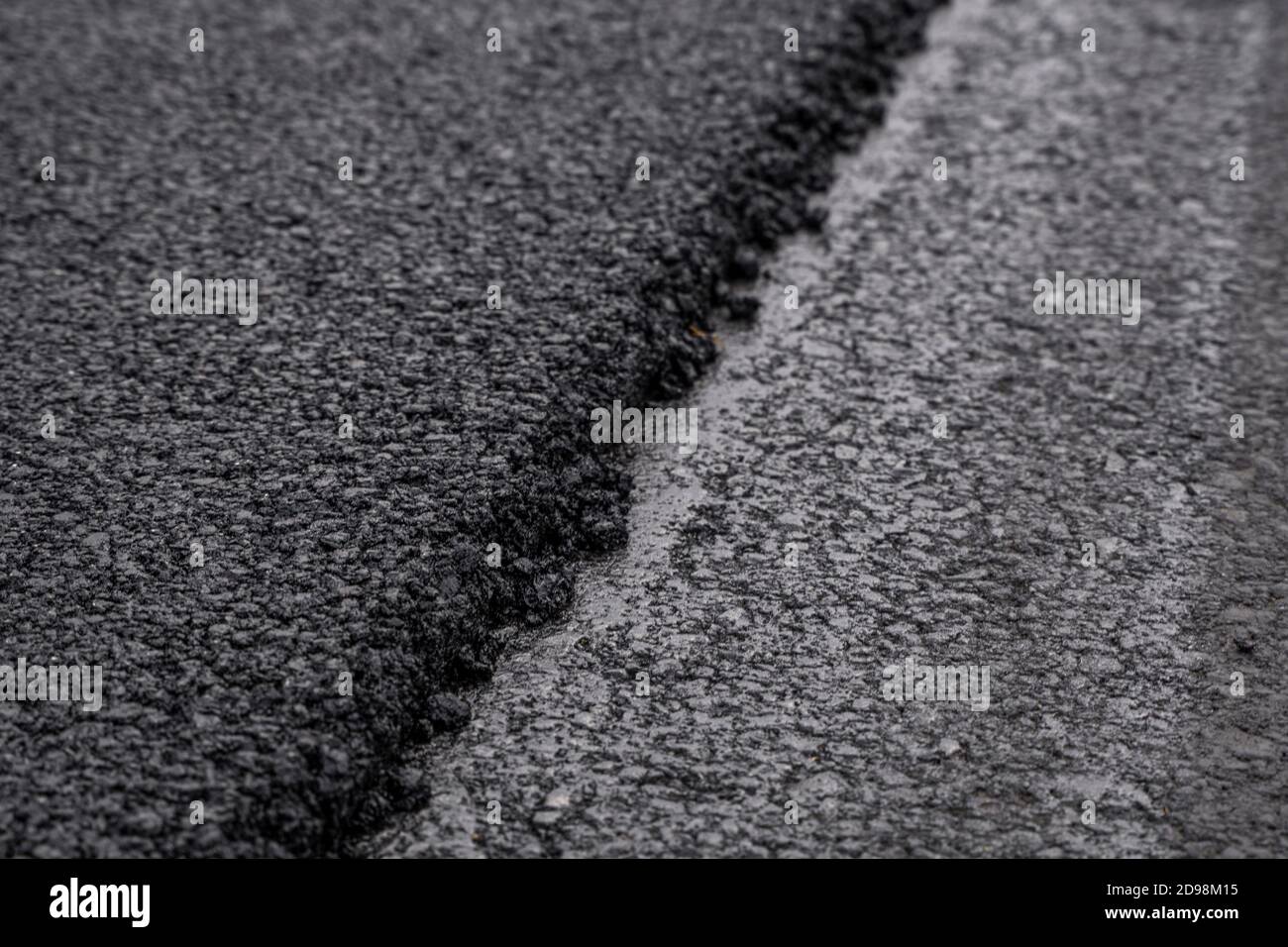 A large layer of fresh hot asphalt. Layer of asphalt raw material in a ...