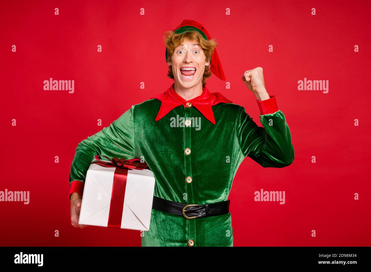 Photo of crazy helper elf hold box raise fist astonished wear green x ...